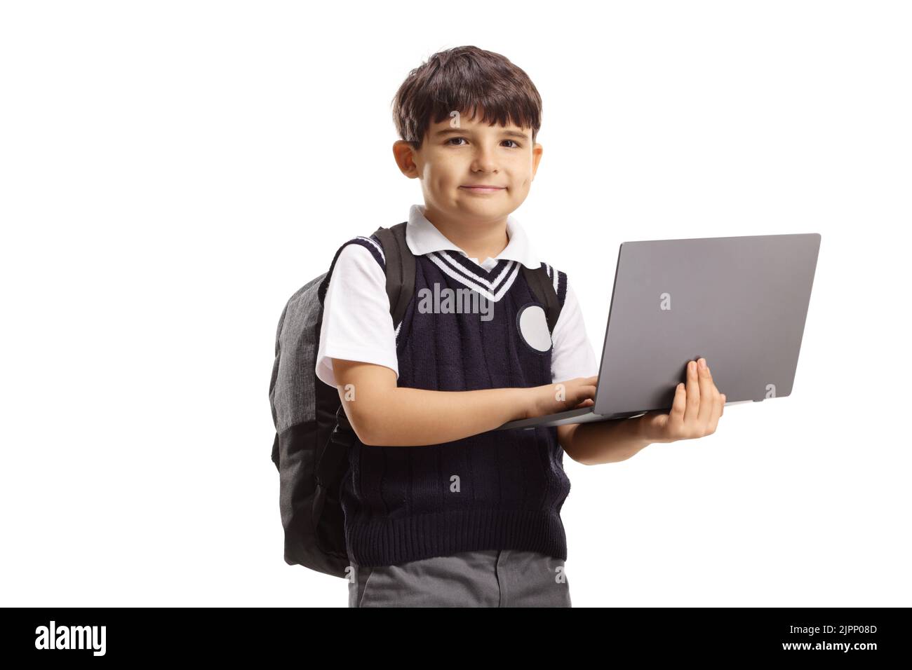 Boy in a school uniform holding a laptop computer isolated on white ...