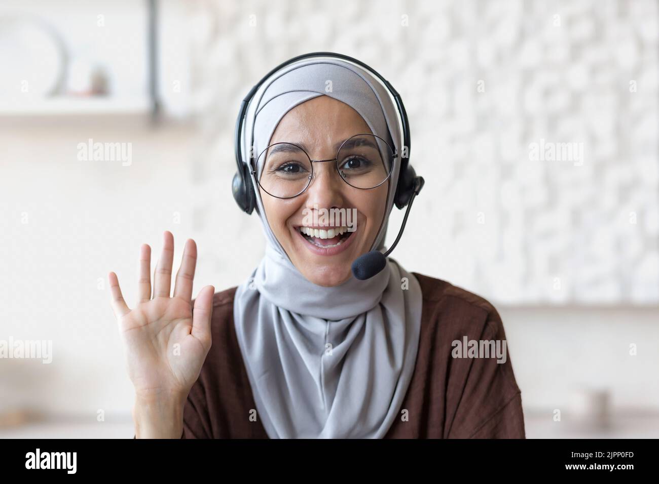 Young beautiful arab woman in hijab muslim working at home remotely ...
