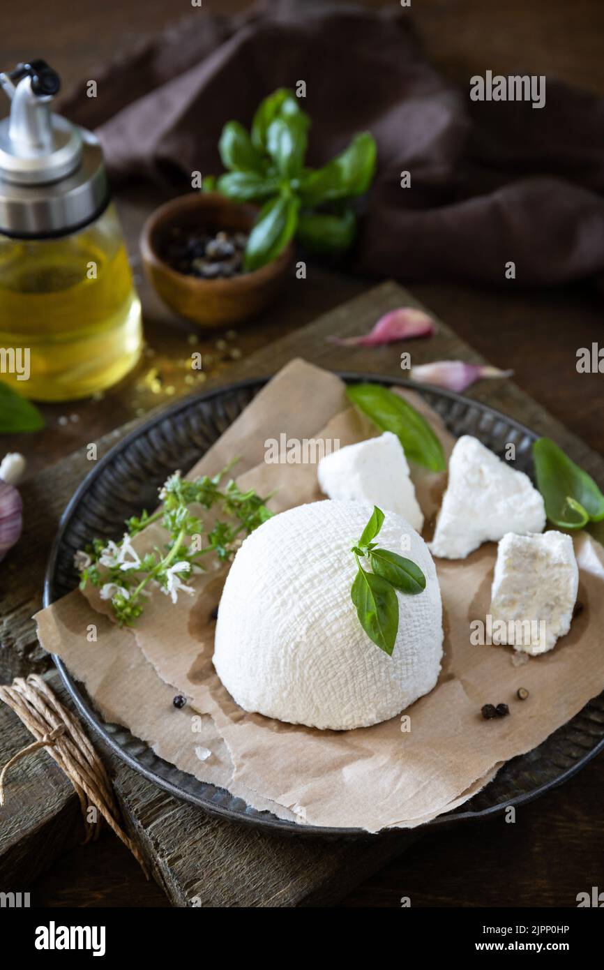 Homemade Italian ricotta cheese or cottage cheese with basil on a ...