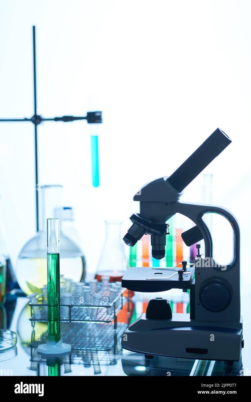 Interior of modern laboratory: bench with microscope and glassware ...