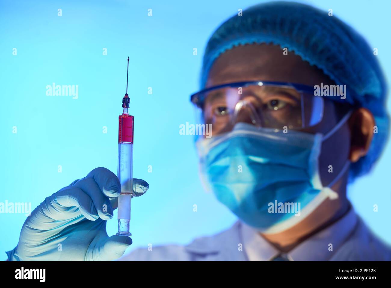 Close-up of confident medical worker wearing safety goggles and mask ...
