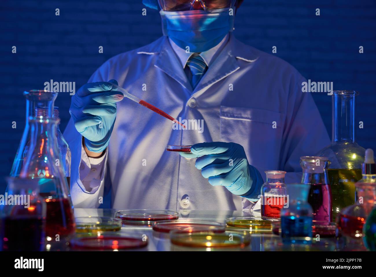 Close-up shot of professional middle-aged scientist wearing white coat ...
