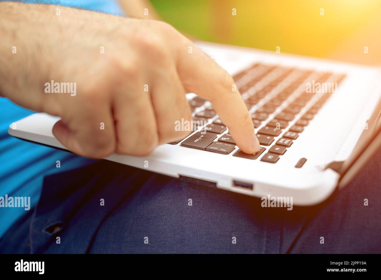 Close-up shot of handsome man's hands touching laptop computer's screen ...