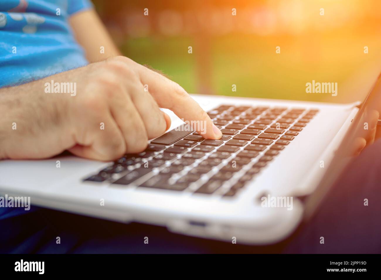 Close-up shot of handsome man's hands touching laptop computer's screen ...
