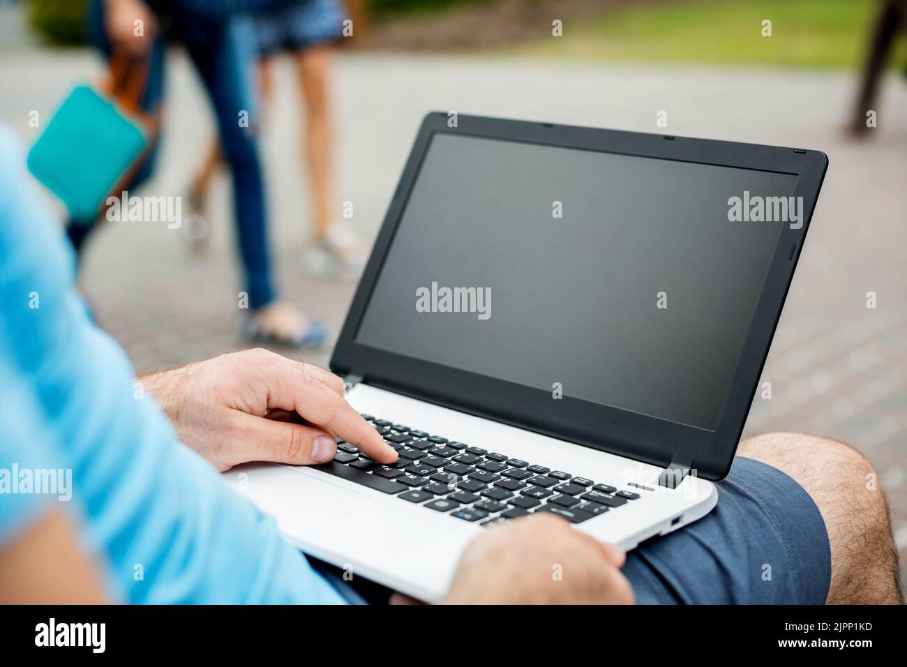 Close-up shot of handsome man's hands touching laptop computer's screen ...