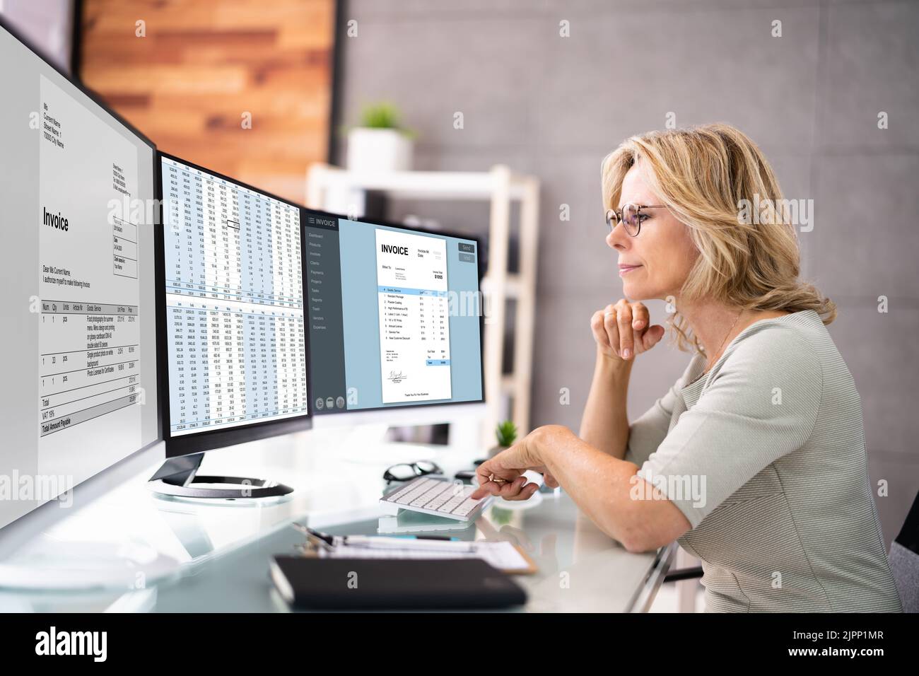 Using Corporate Invoice Spreadsheet On Computer Monitors Stock Photo ...