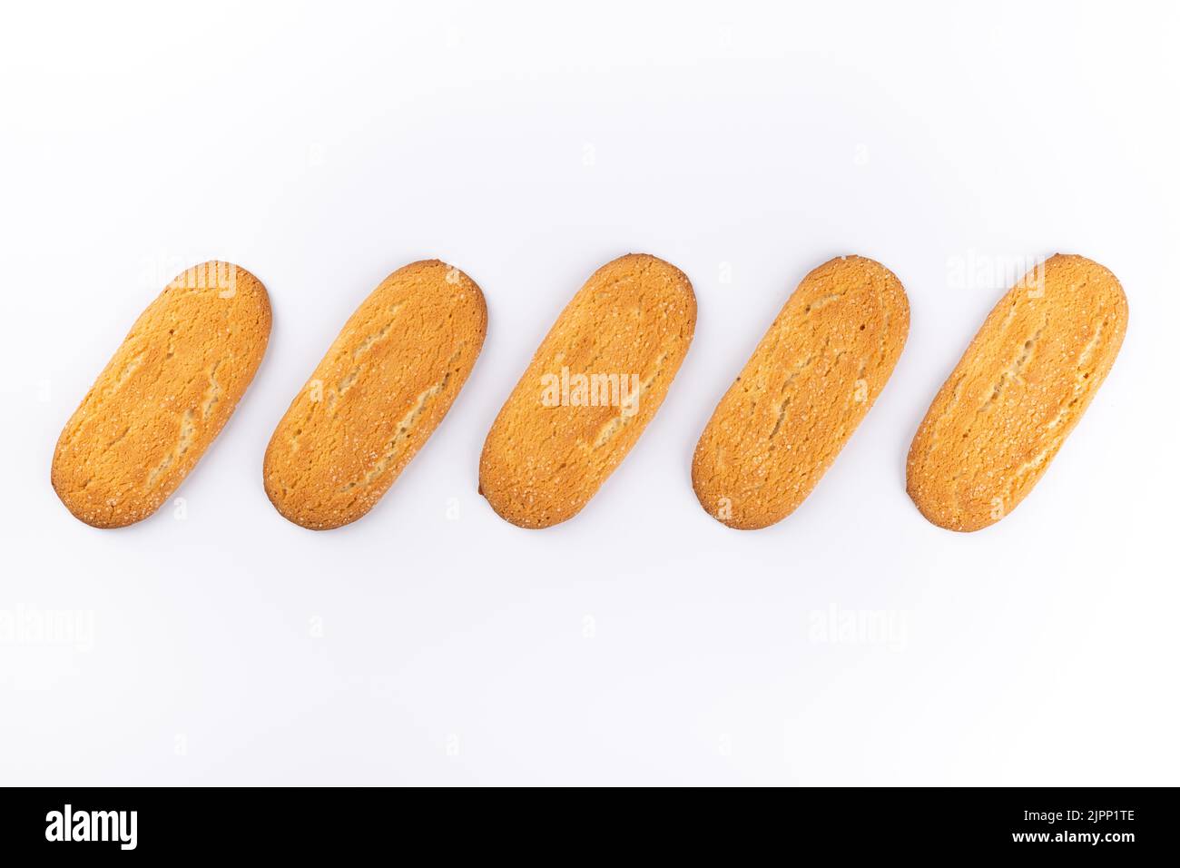Elongated sugar cookies in a line on a white background. Breakfast and ...