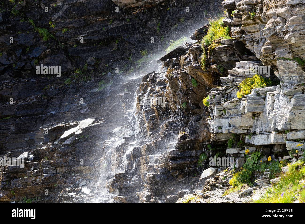 A scenic shot of waterfalls flowing through rough rock formations Stock ...