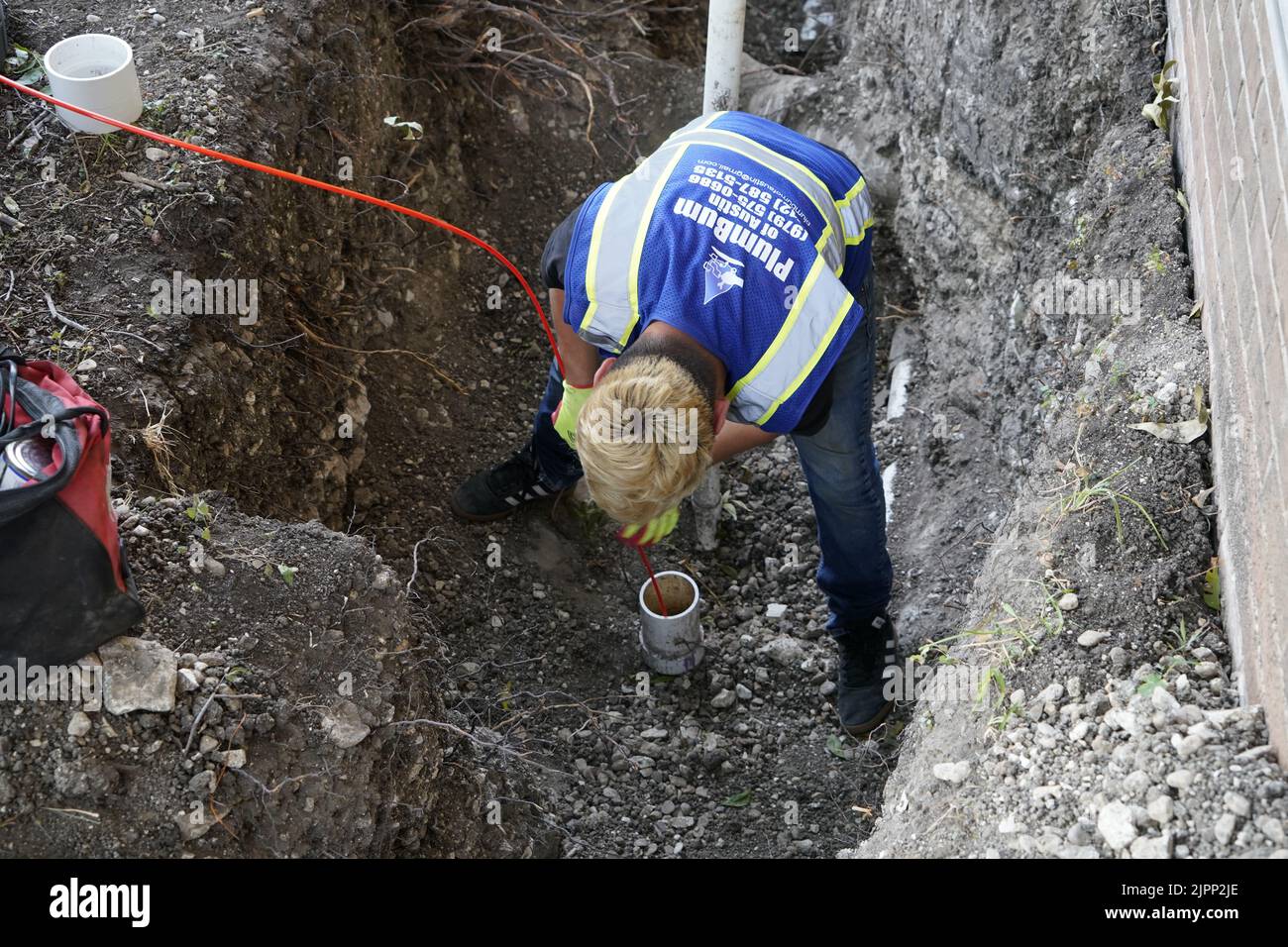 Austin Texas USA, August 5 2022: Plumbers investigate an old buckled ...