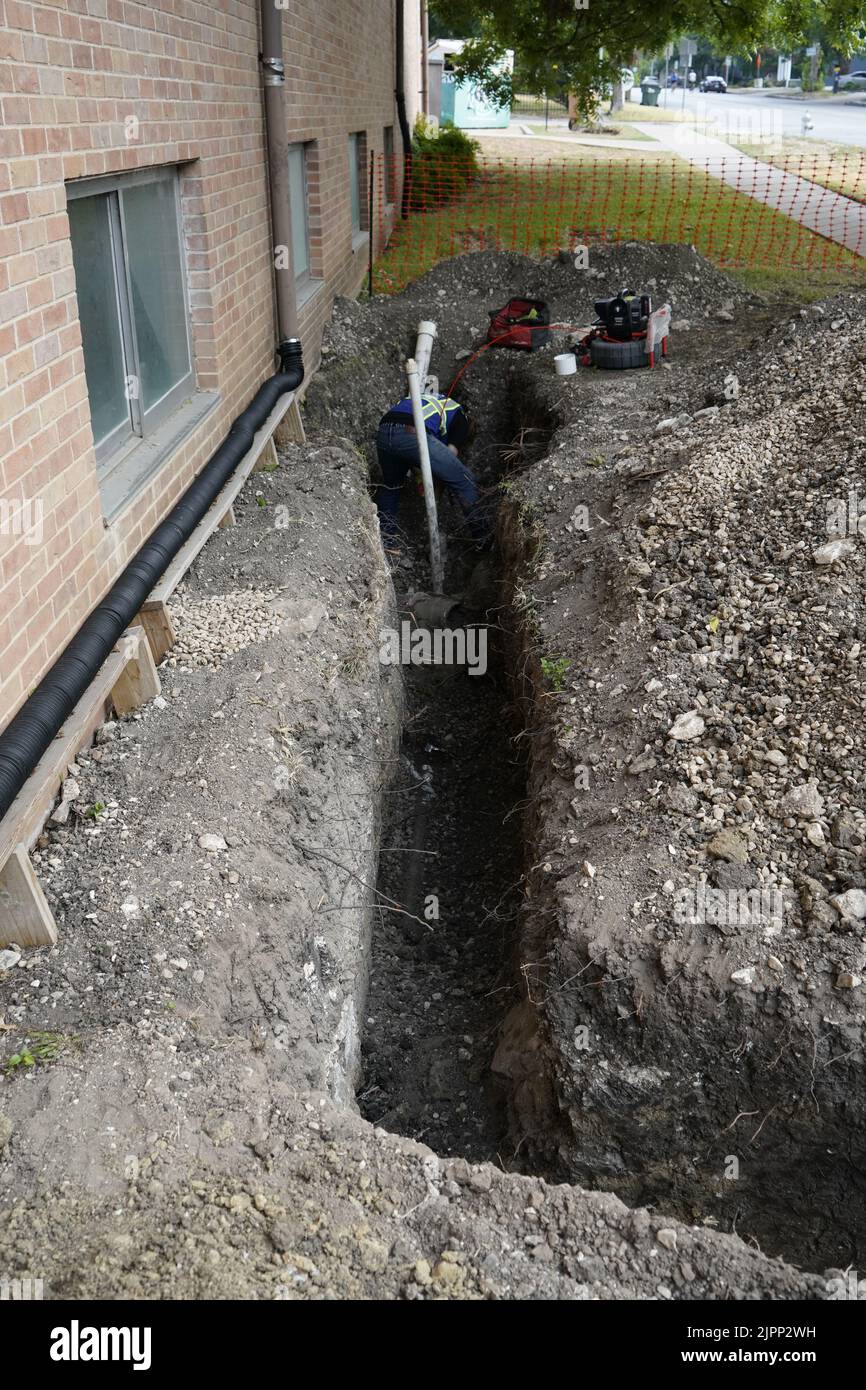 Austin Texas USA, August 5 2022: Plumbers investigate an old buckled ...