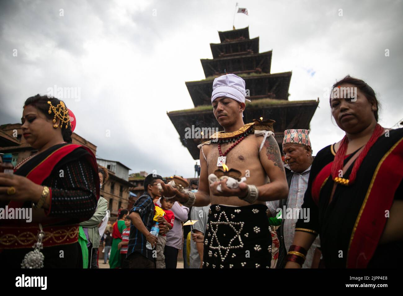 Bhaktapur, Nepal. 19th Aug, 2022. Devotees with lit oil lamps perform ...