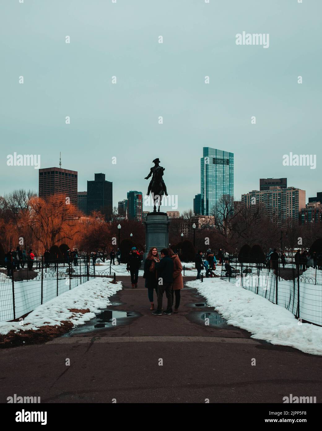 A vertical shot of people enjoying the winter season in Boston Public ...