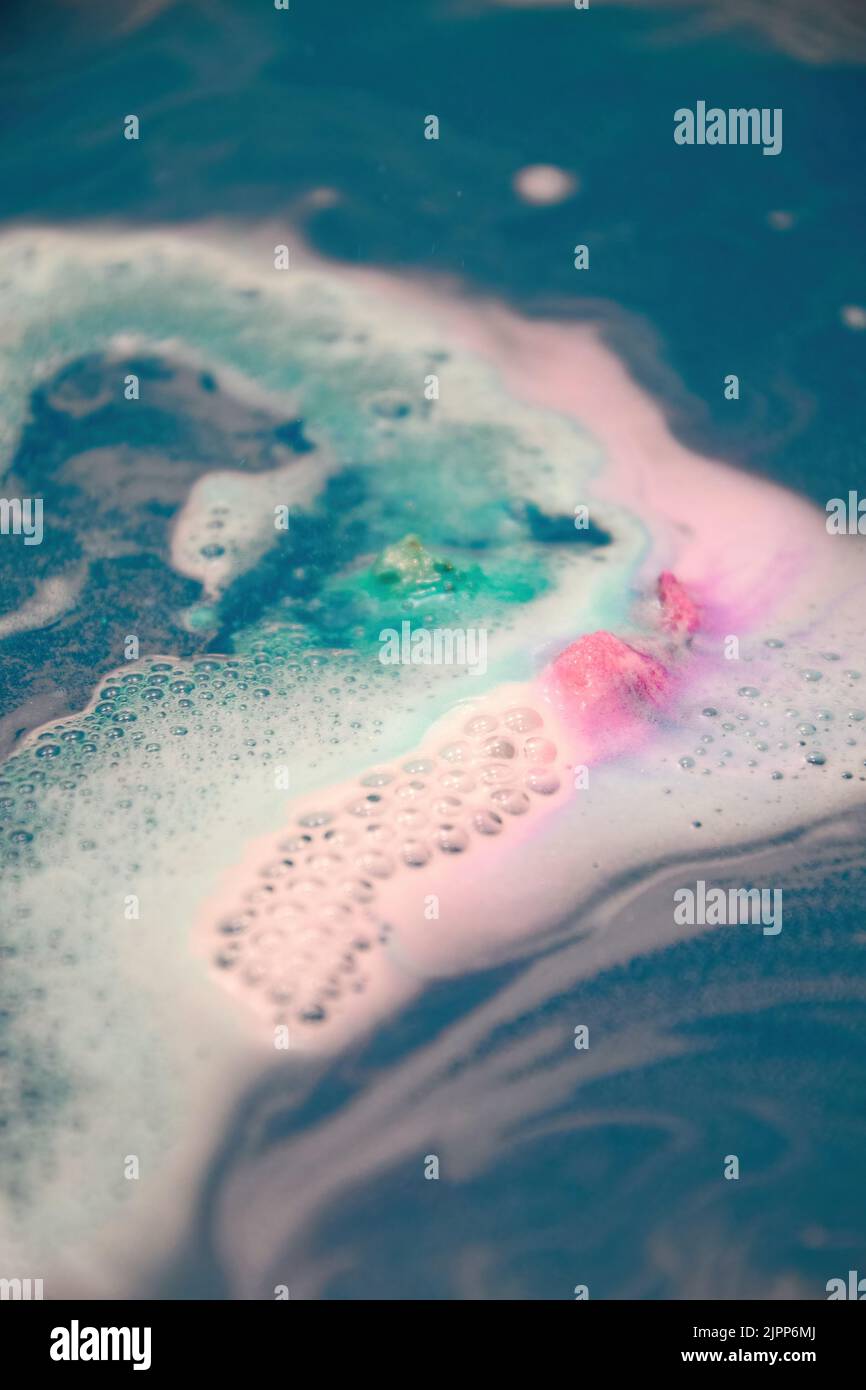 Colorful foam and bubbles in the bath blue water. Abstract backgrounds ...
