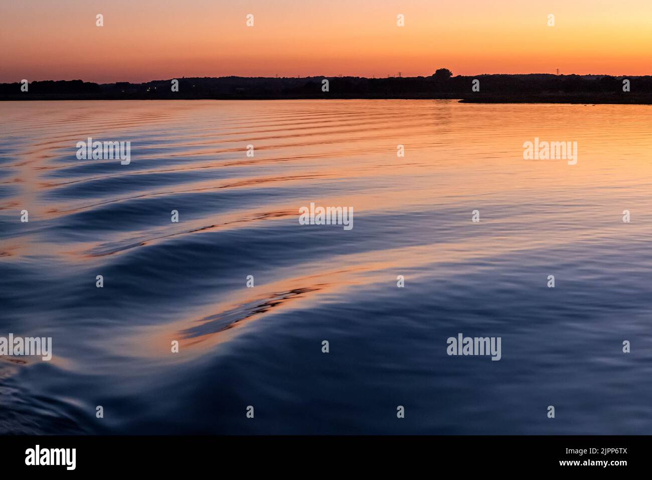 Bow waves at sunset, Poole Harbour, summertime Stock Photo - Alamy