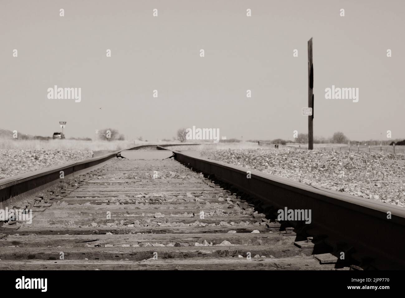 An empty railroad track surrounded by plains Stock Photo - Alamy