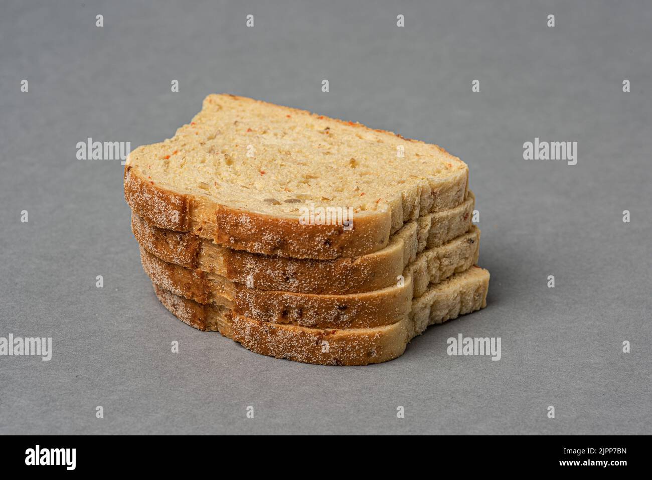 Four loaves of bread on top of each other with a gre background Stock ...
