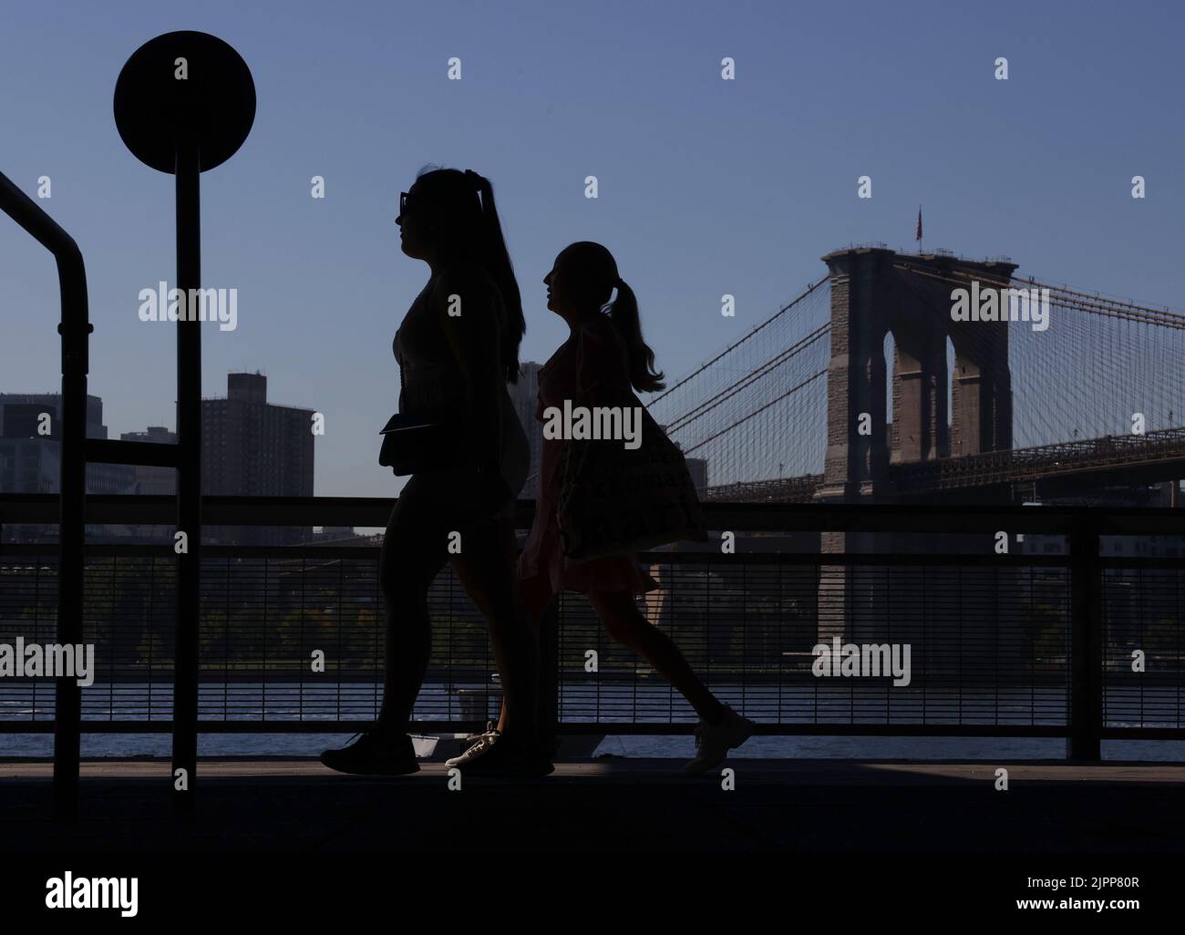 New York, United States. 19th Aug, 2022. Pedestrians walk under the FDR ...