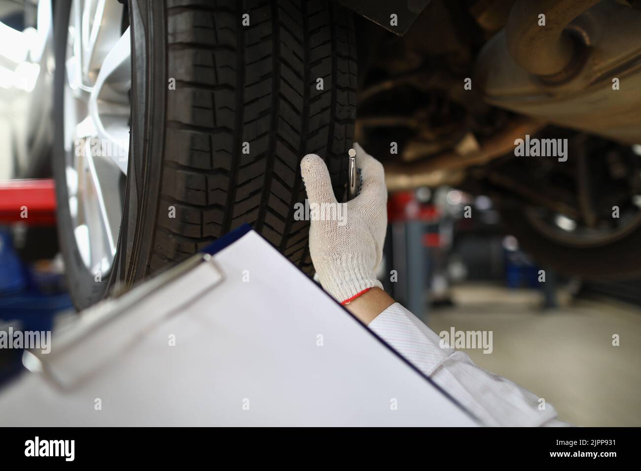 Man mechanic working under car at car service station Stock Photo - Alamy