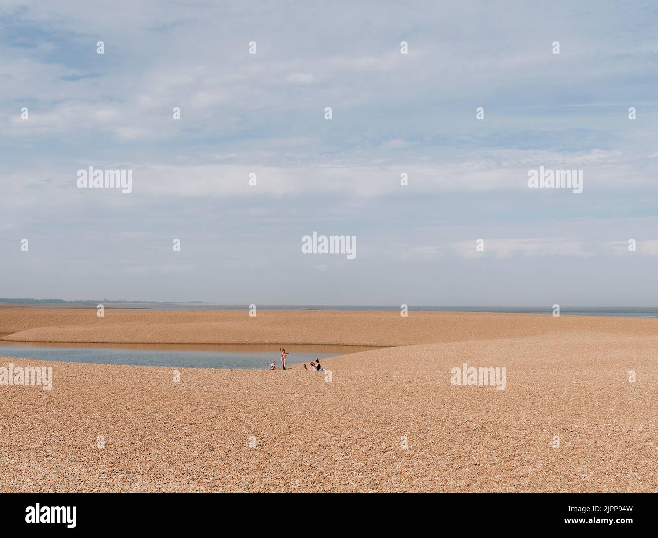 Summer tourists enjoying the shingle beach at Shingle Street on the ...