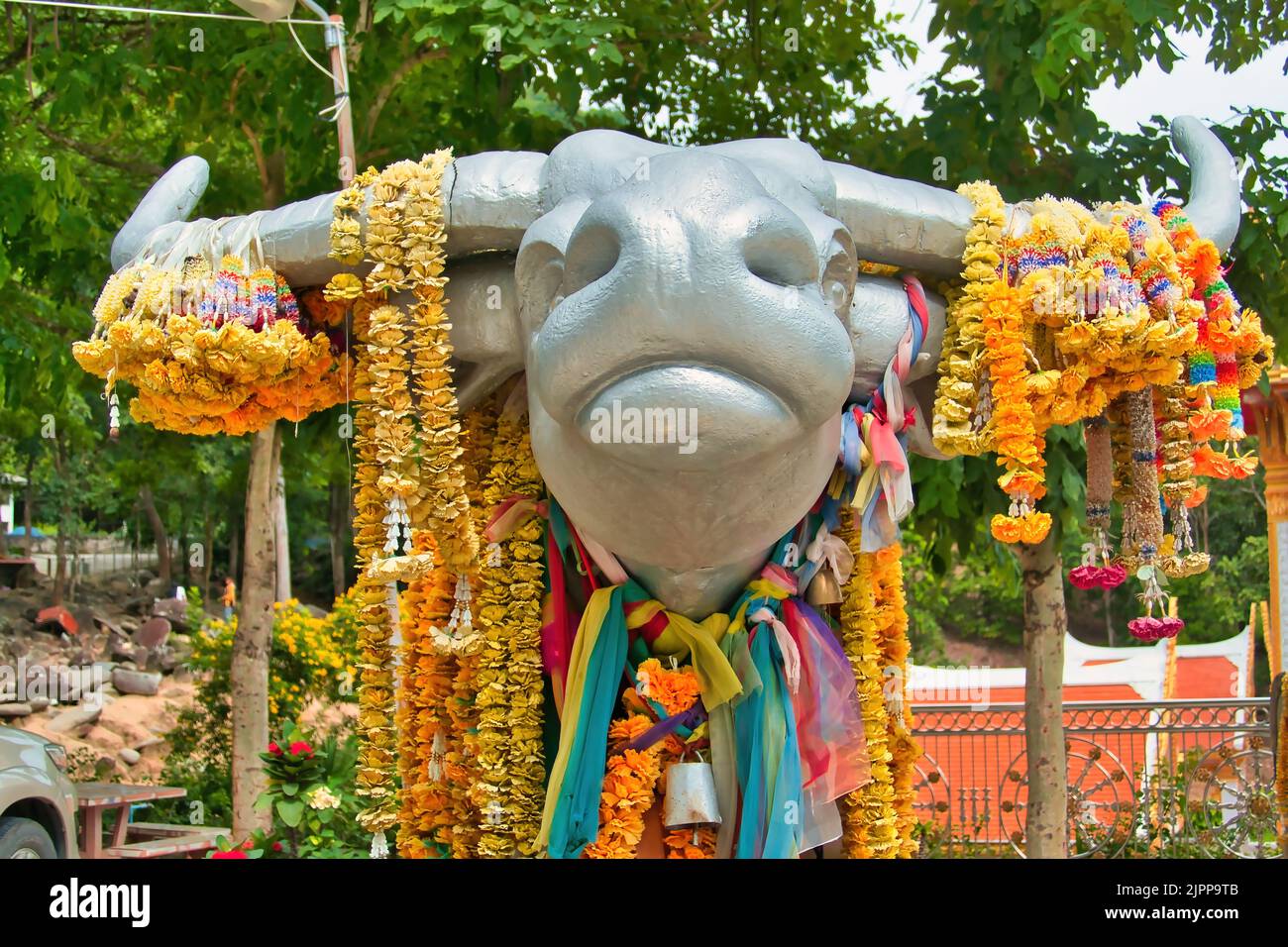 Head of a giant silver buffalo, decorated with flower garlands, on the ...