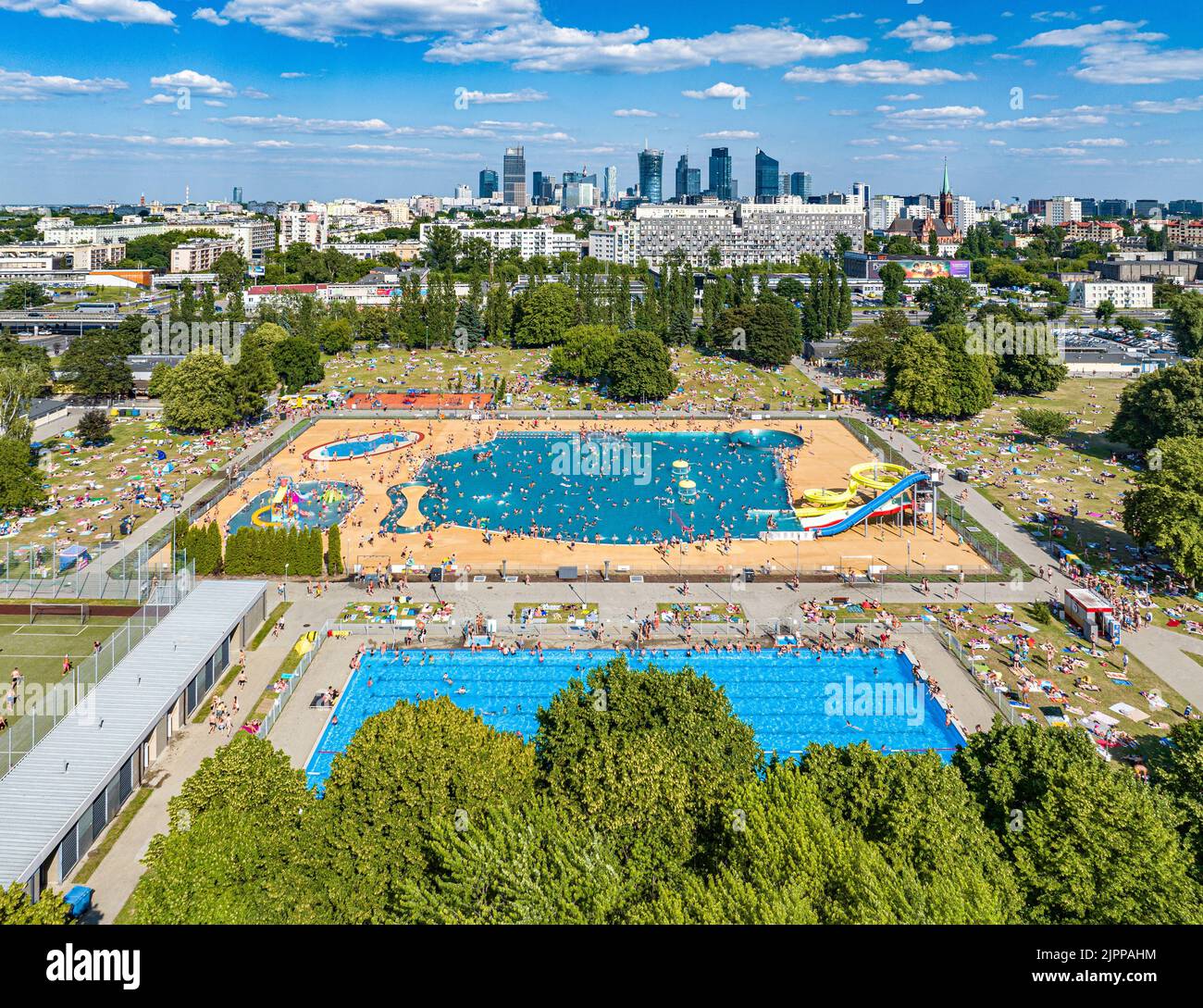 An aerial view of the waterpark area with slides and big pools on a hot ...