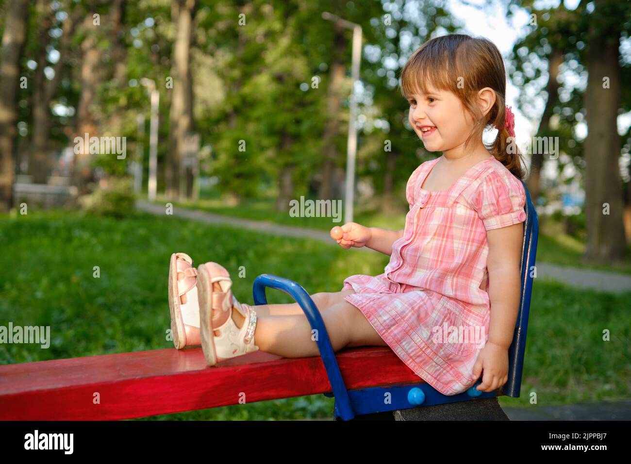 Cute baby girl Playing At Playground In Summer Sunny Day. Little girl ...