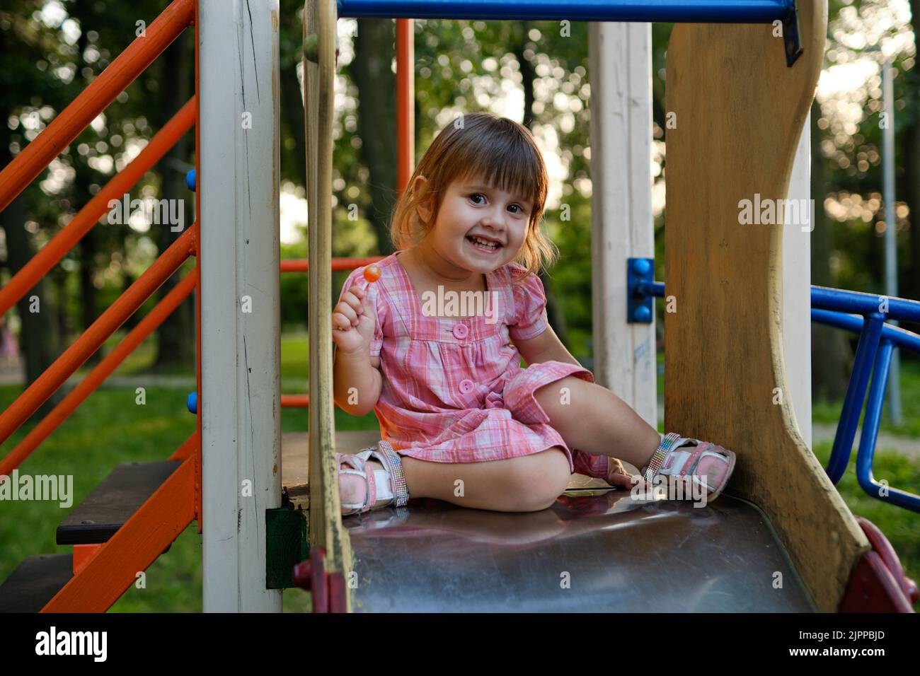 Cute baby girl Playing At Playground In Summer Sunny Day. Little girl ...