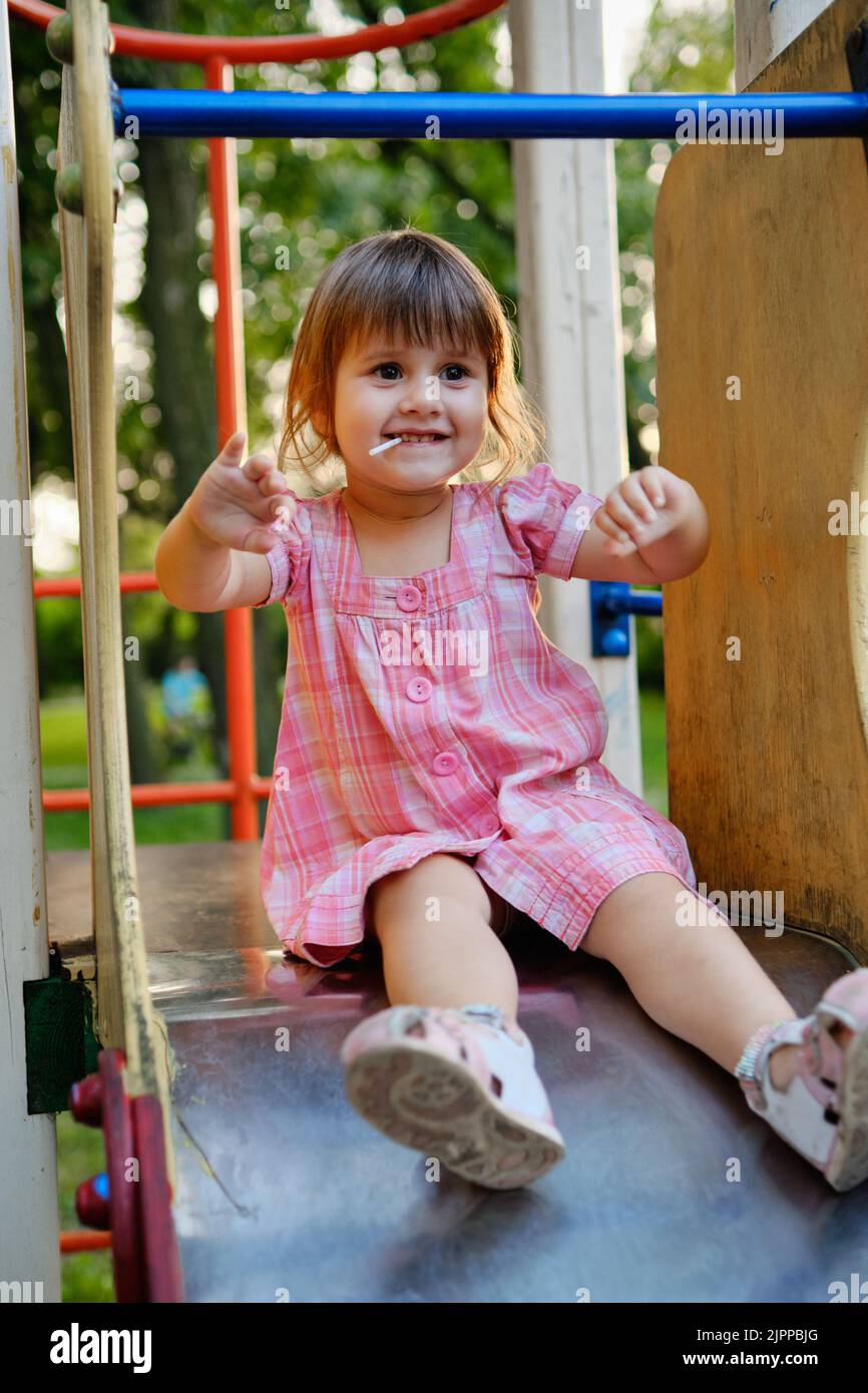 Cute baby girl Playing At Playground In Summer Sunny Day. Little girl ...