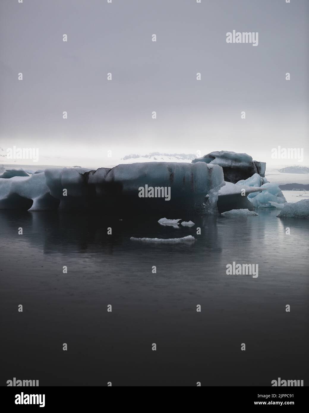 A vertical shot of an iceberg swimming in the Arctic Ocean Stock Photo ...