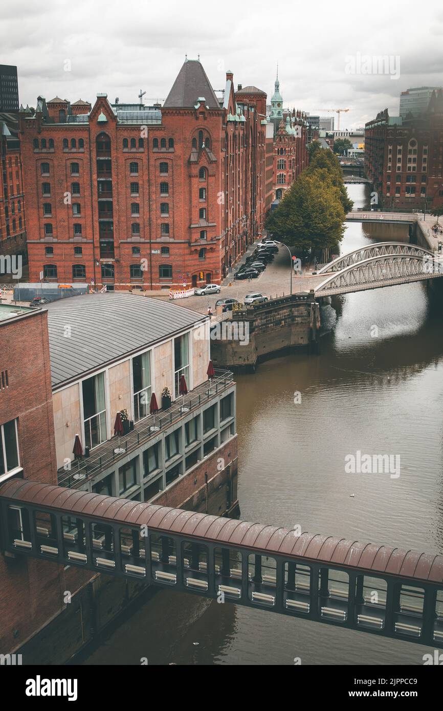 A vertical shot of a Kehrwiederfleet bridge of Hamburg with a red ...