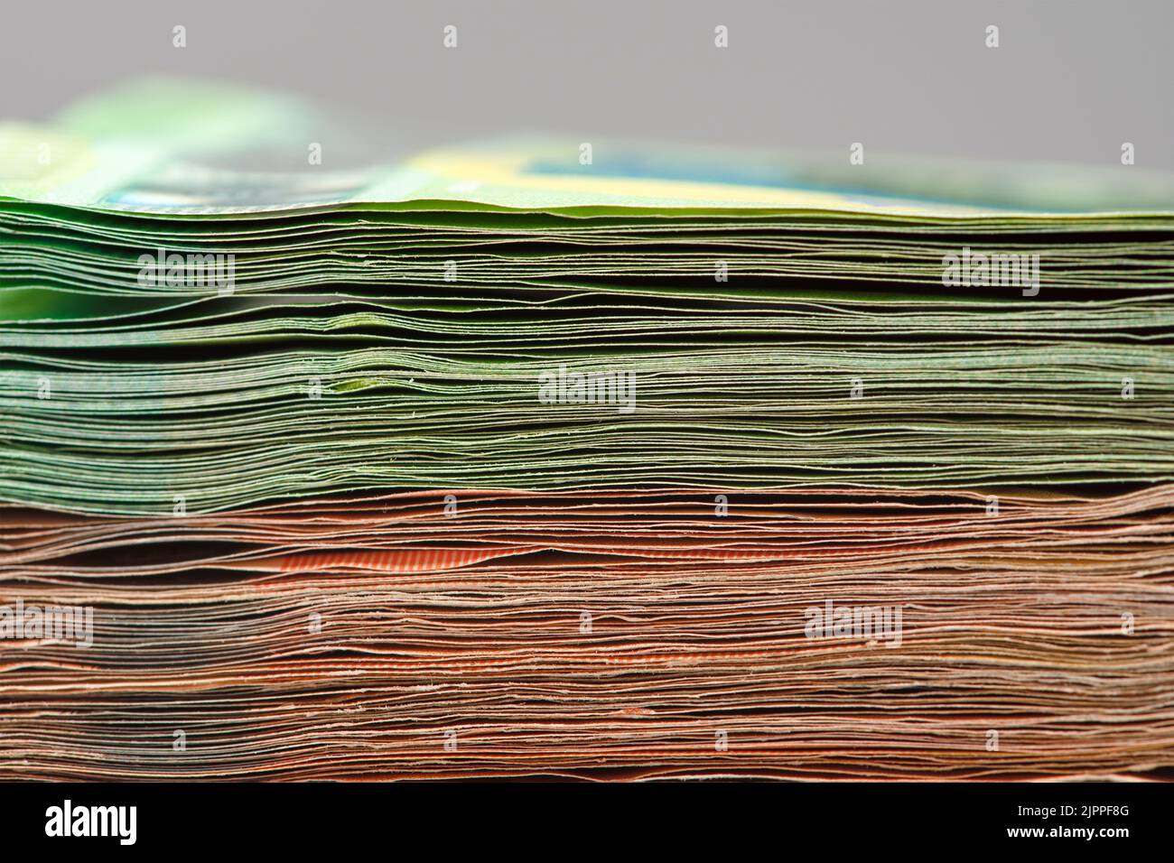 Close-up of a stack of paper bills, side view. Euro banknotes stacked ...