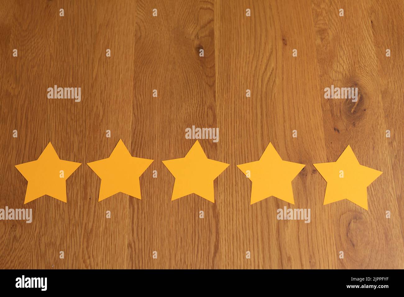 A five yellow stars on a wooden floor Stock Photo - Alamy