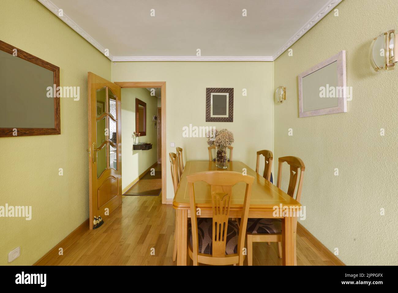 Dining room with wooden table and matching chairs, oak parquet floors ...
