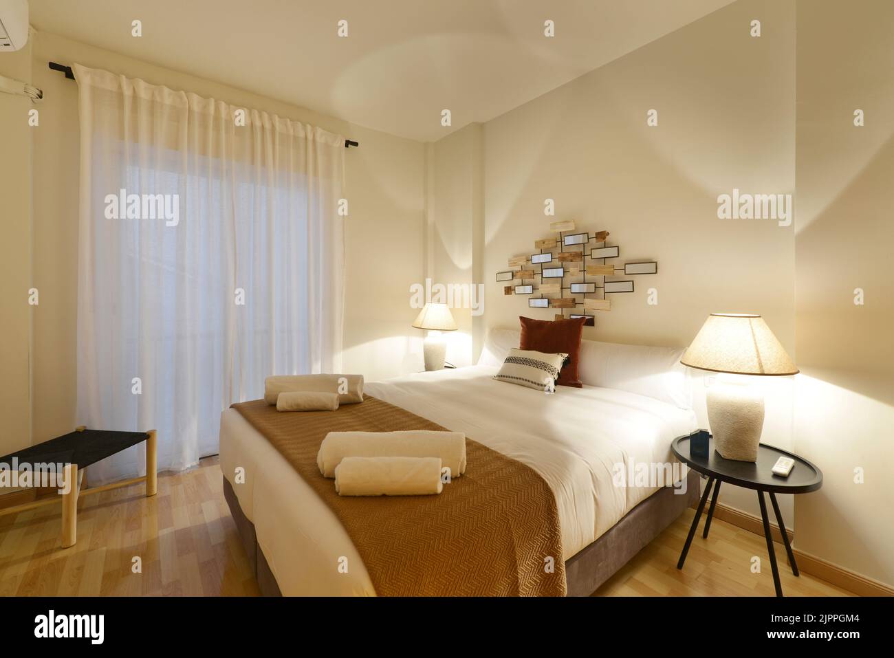 Bedroom decorated in soft tones, twin lamps, white curtains and clean ...