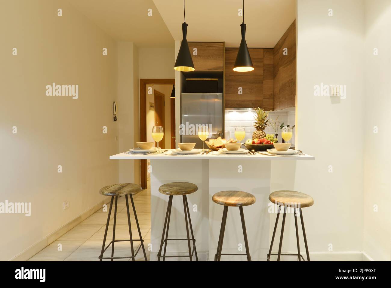 Studio with open kitchen, white breakfast bar with juices, industrial ...