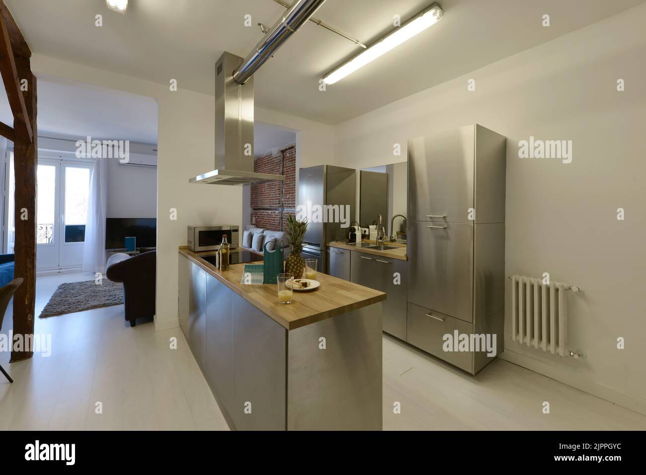 Open kitchen with stainless steel furniture, matching appliances with ...