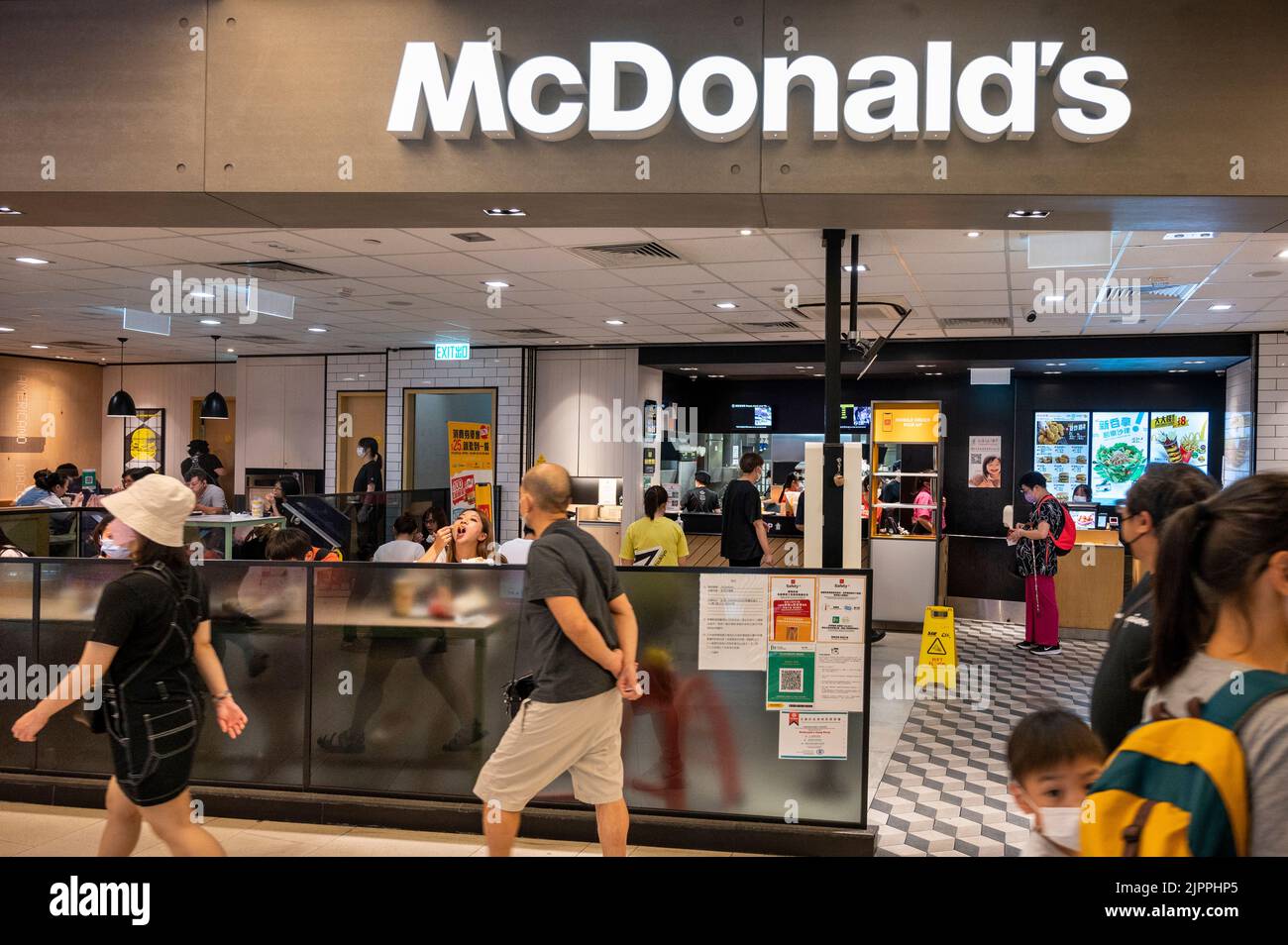 Shoppers walk past the American multinational fast-food hamburger ...