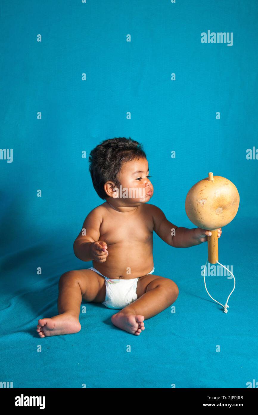 Native American baby, from the Santa Clara Pueblo in New Mexico holding ...