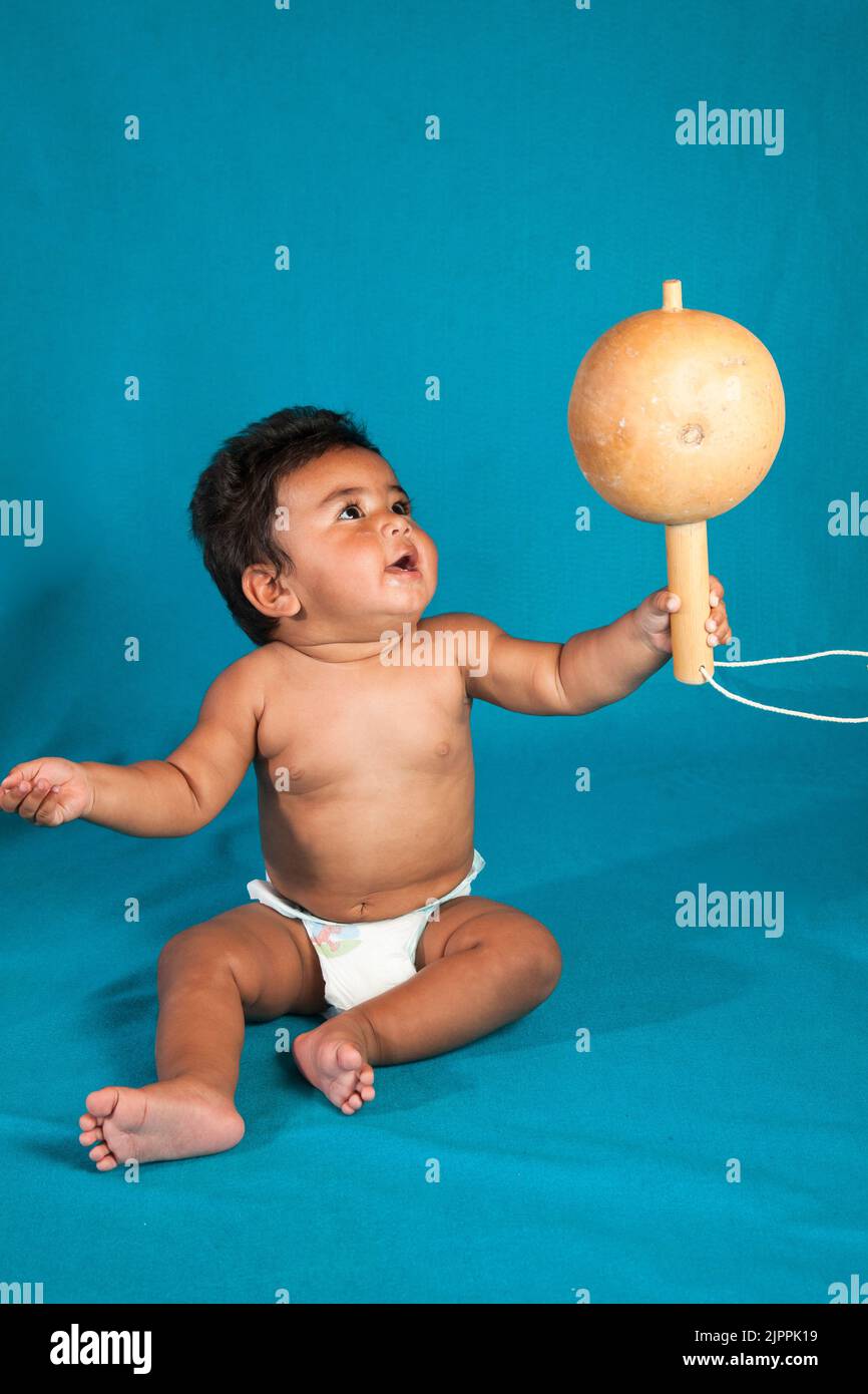 Native American baby, from the Santa Clara Pueblo in New Mexico plays ...