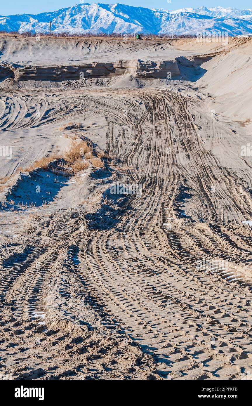 Tire and tread tracks are quite evident in the soil of an active solid ...