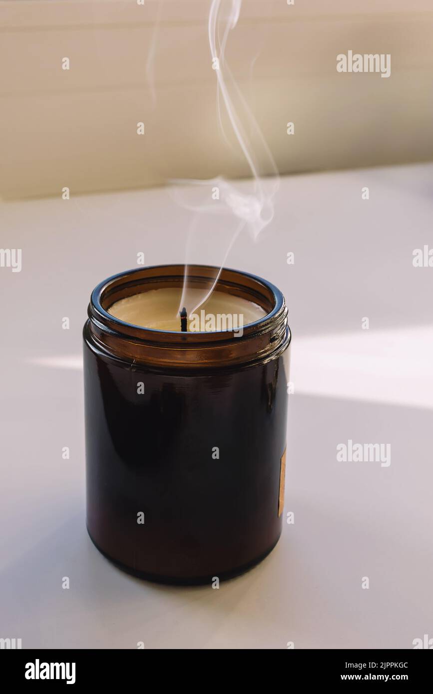 Glass candle with smoke close-up, minimalist lifestyle Stock Photo - Alamy