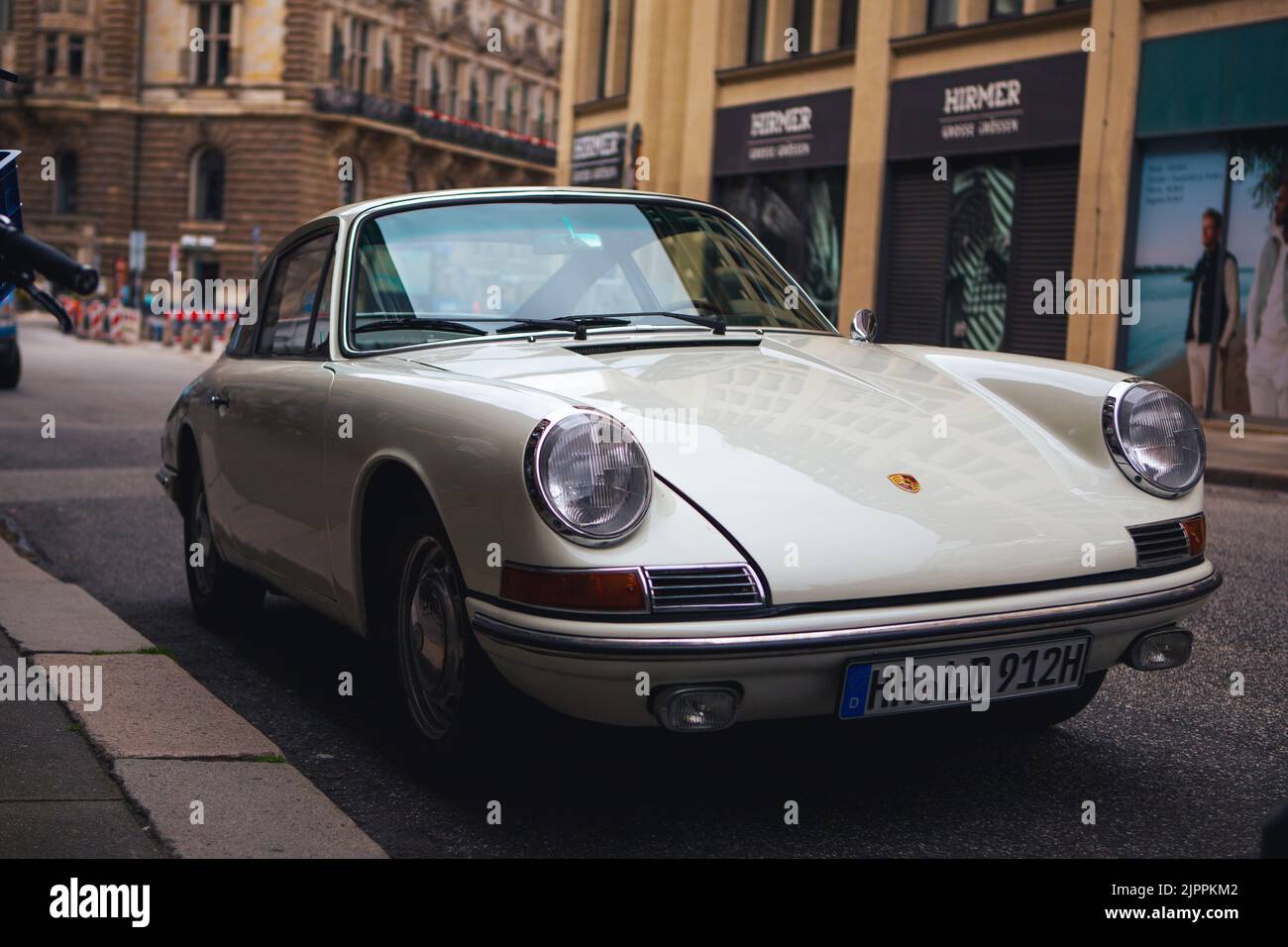 A closeup shot of a vintage Porsche 911 car model parked on a street ...
