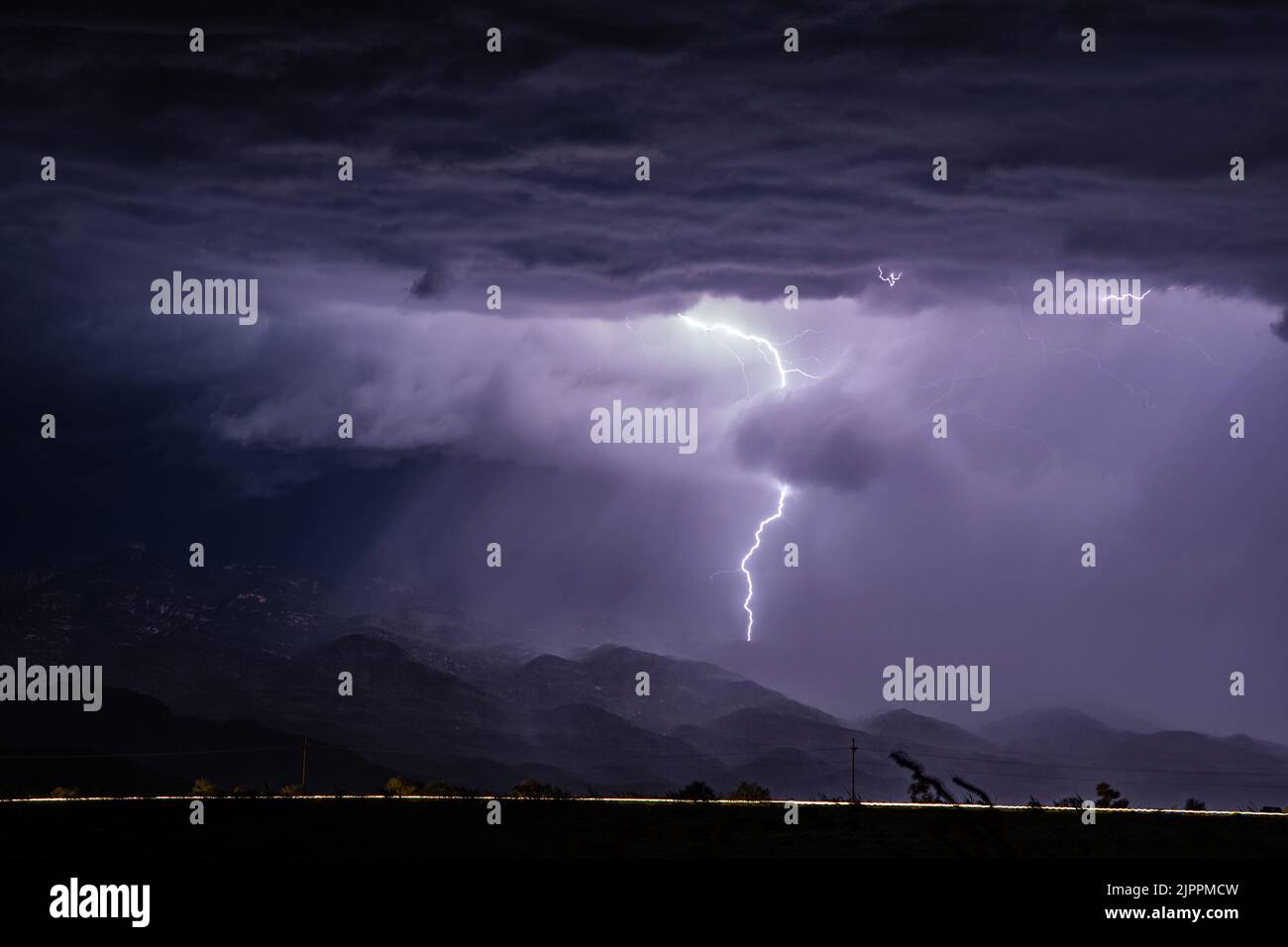Lightning at night over mountains Stock Photo - Alamy