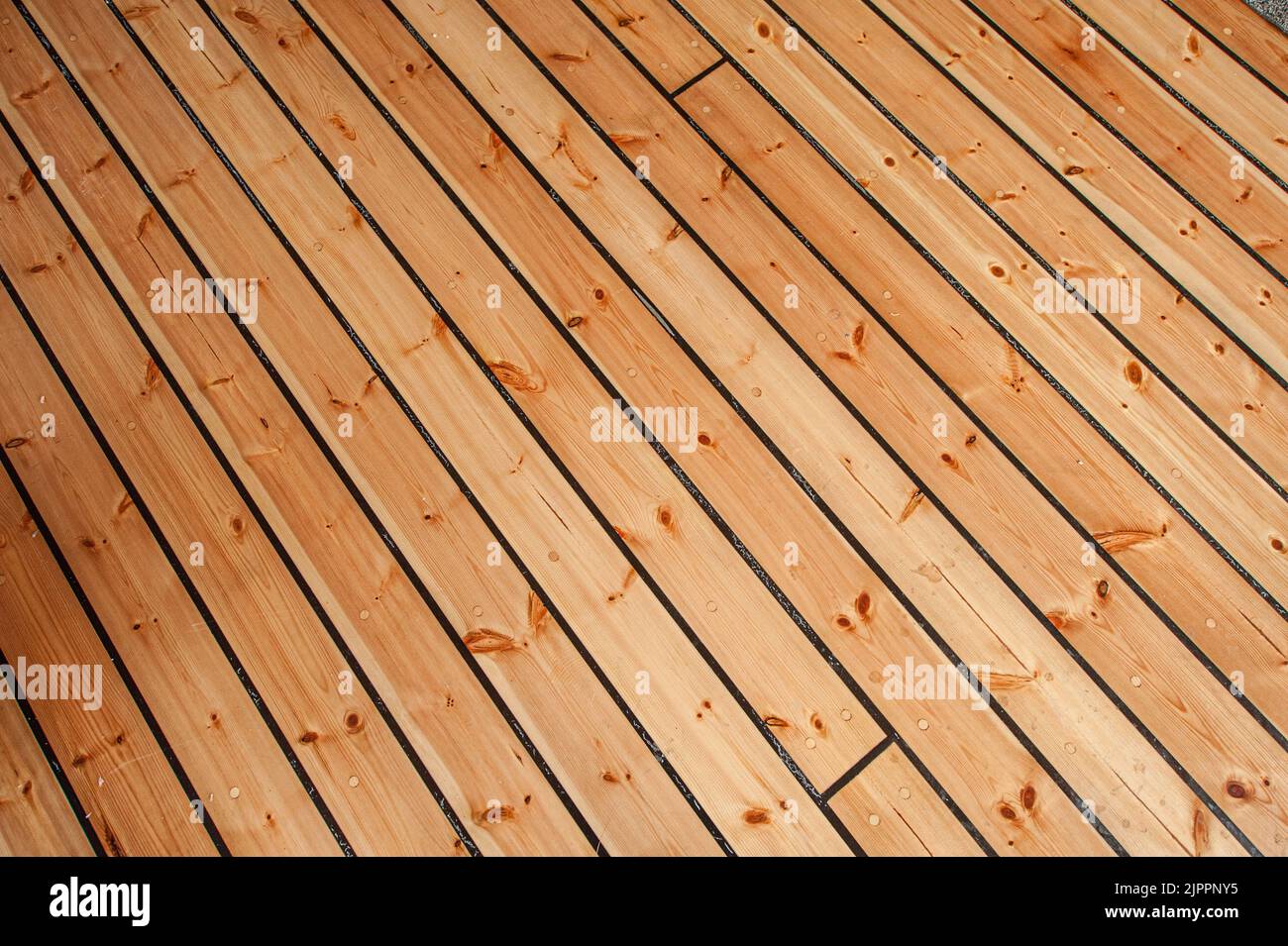 A top view of a wooden floor with symmetrical pieces making a pattern ...
