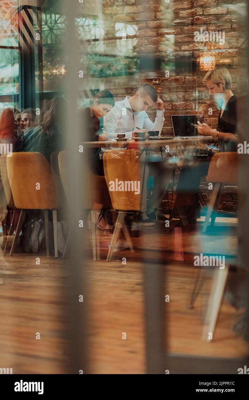Happy businesspeople smiling cheerfully during a meeting in a coffee ...