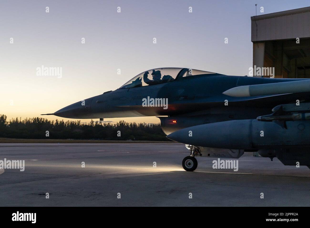 An F-16 Fighting Falcon taxis out for a night time training sortie at ...