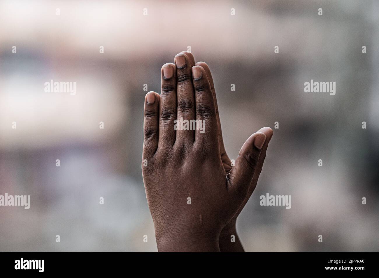 Hands together praying sign Stock Photo - Alamy