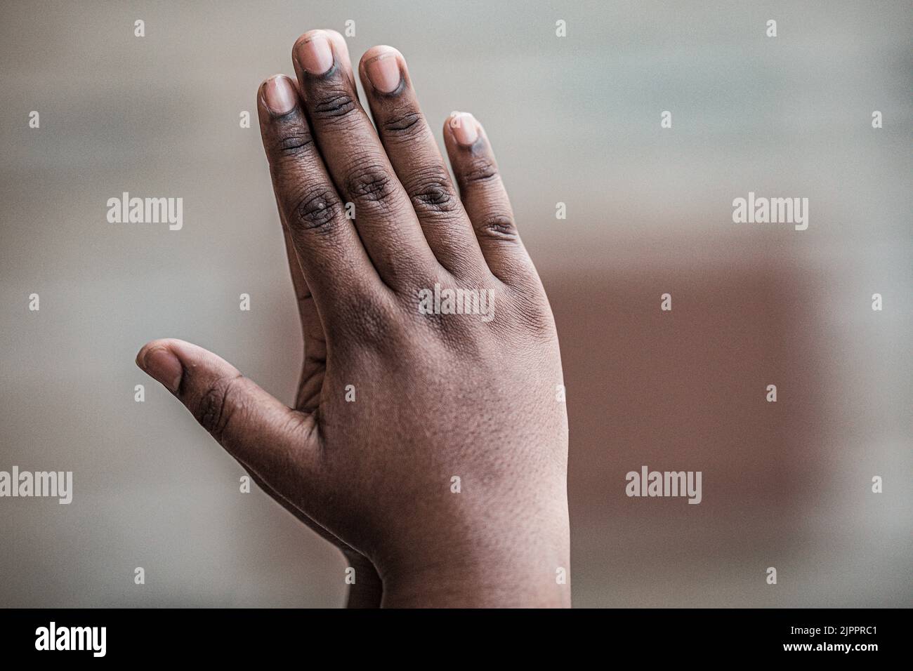 Hands together praying sign Stock Photo - Alamy
