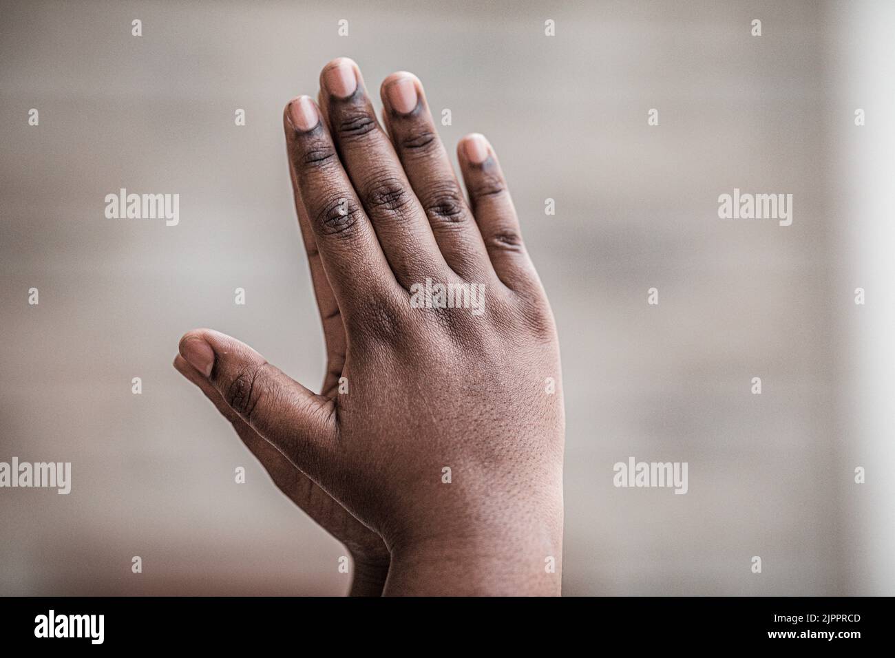 Hands together praying sign Stock Photo - Alamy
