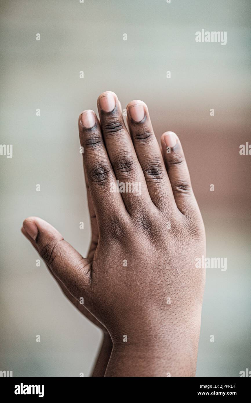 Hands together praying sign Stock Photo - Alamy